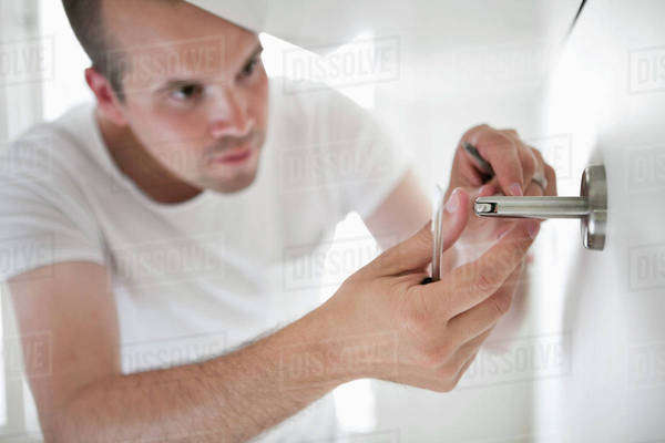 Man fixing handle - Royalty-free Stock Photo | Dissolve