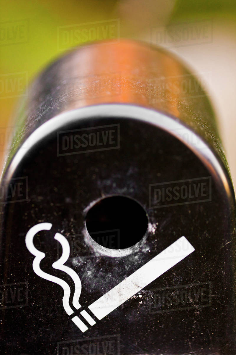 Close-up of cigarette sign on ashtray - Stock Photo - Dissolve