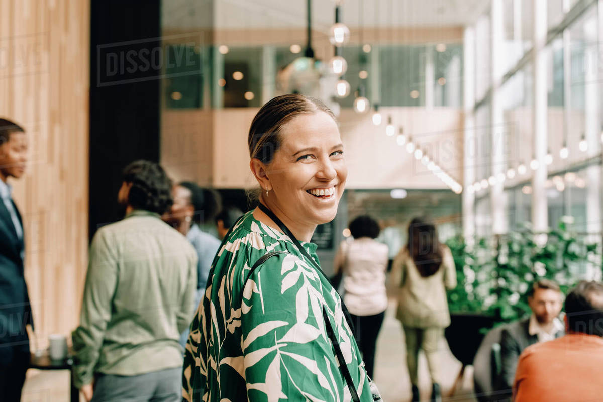 Side view portrait of happy female entrepreneur looking over shoulder ...