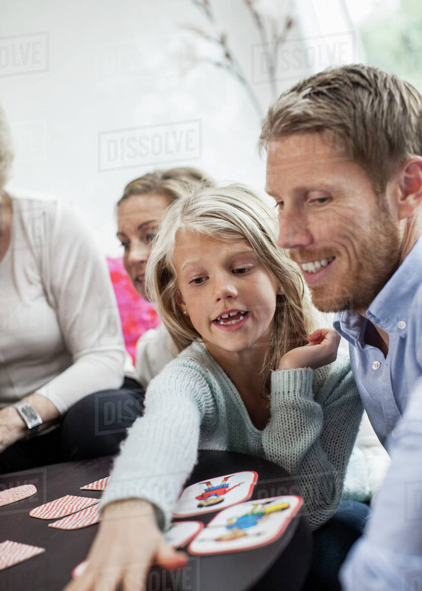 Family playing puzzle game at home - Royalty-free Stock Photo | Dissolve