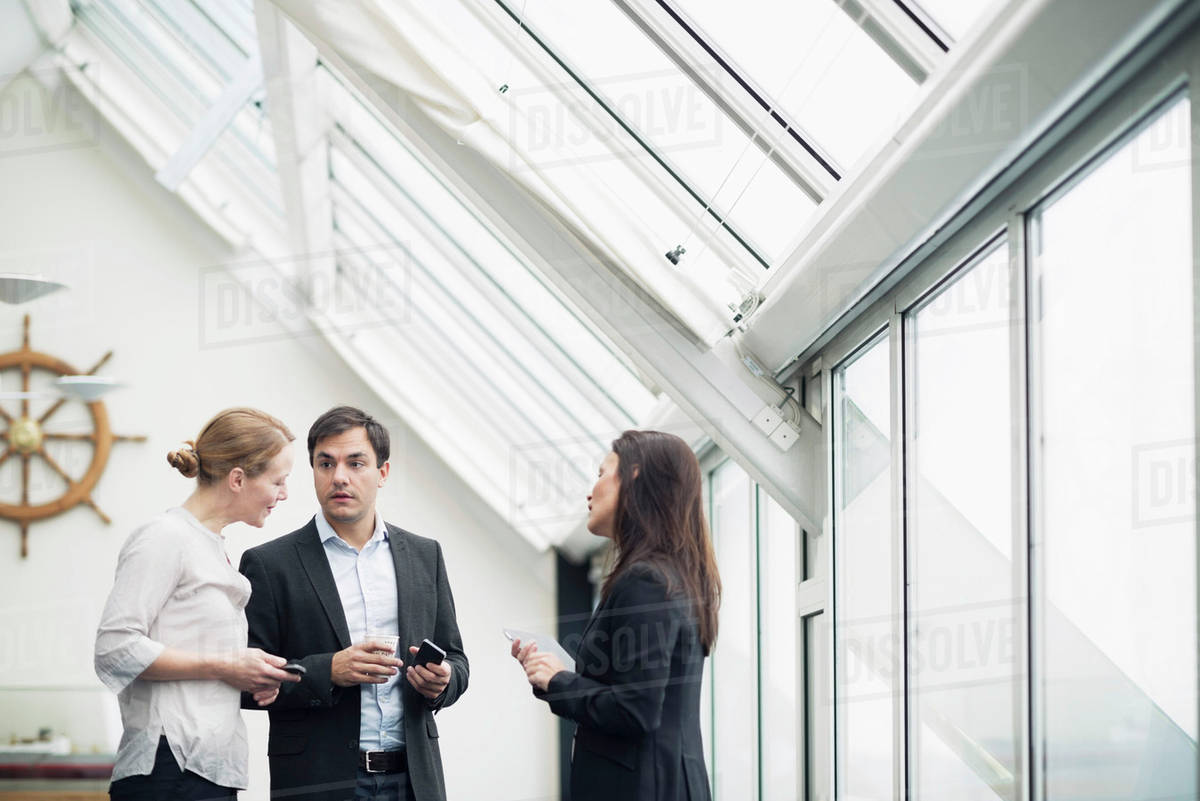 Business people communicating in office - Royalty-free Stock Photo ...