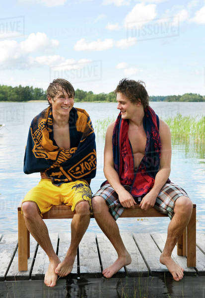 Two friends on jetty - Stock Photo - Dissolve