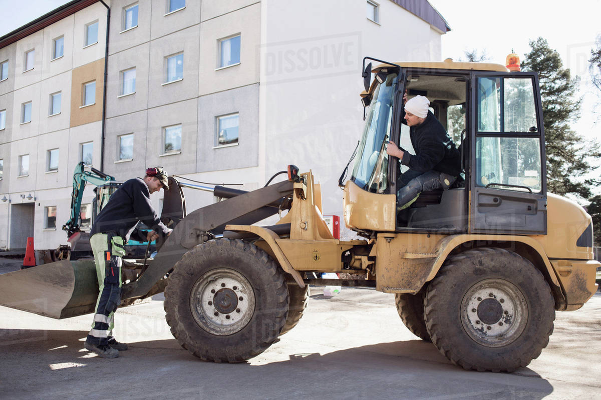 Workers using excavator at construction site - Royalty-free Stock Photo ...