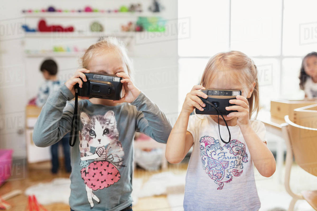 Little girls holding toy cameras in classroom - Royalty-free Stock ...