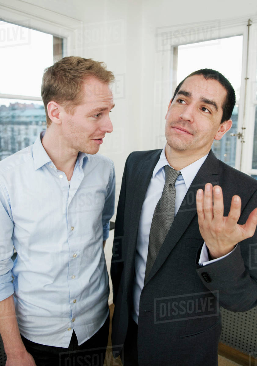 Two men discussing - Royalty-free Stock Photo | Dissolve