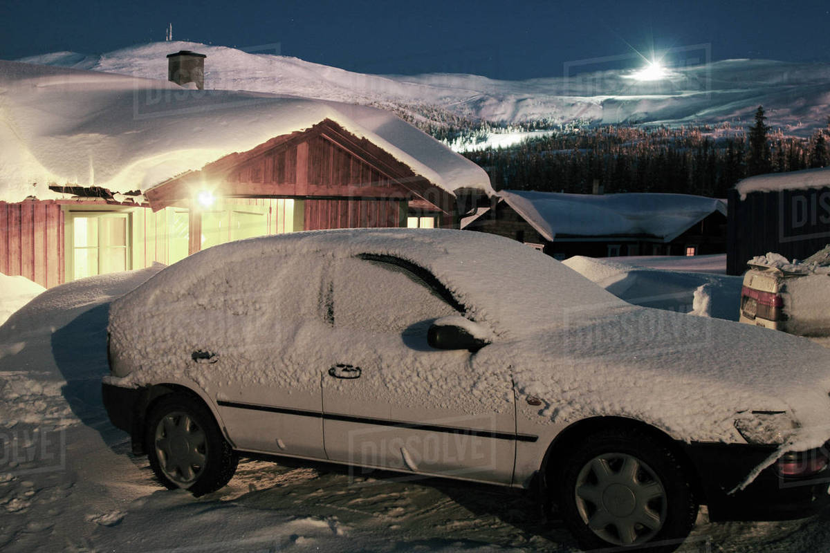 Snow covered car parked outside house at dusk - Royalty-free Stock ...