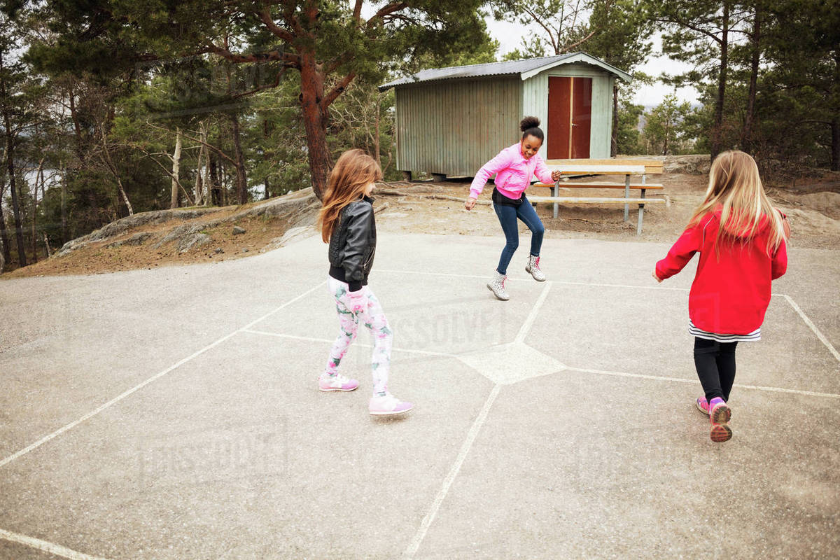 High angle view of girls playing in ground outside school - Royalty ...