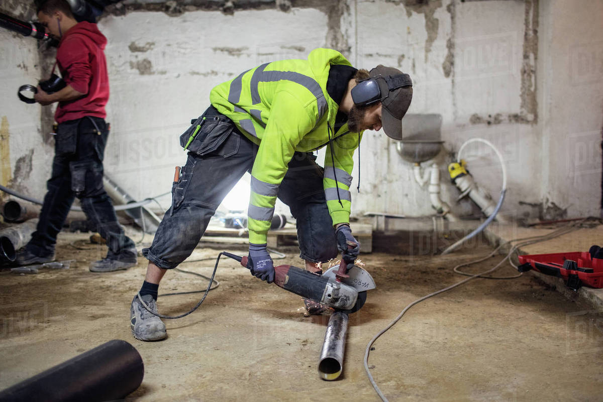 Plumbers working on pipes in abandoned basement - Royalty-free Stock ...