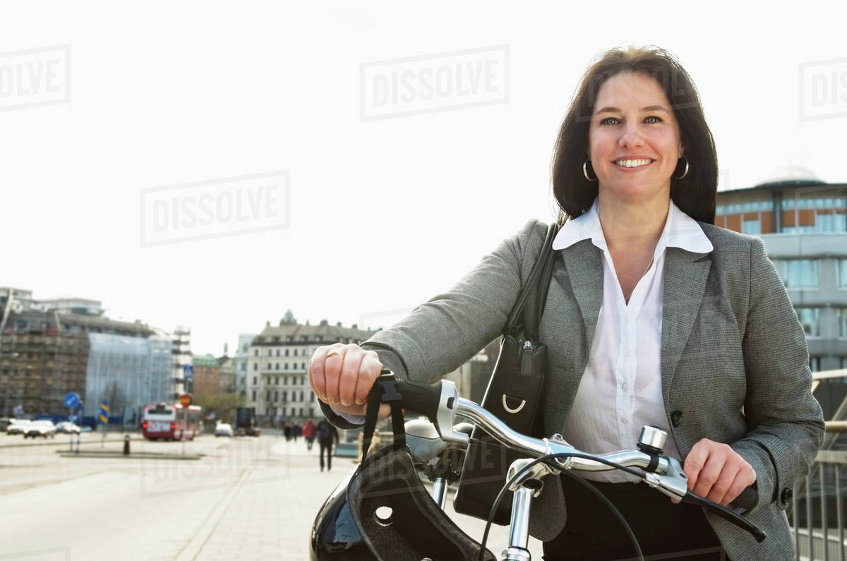 Woman leading bike - Stock Photo - Dissolve