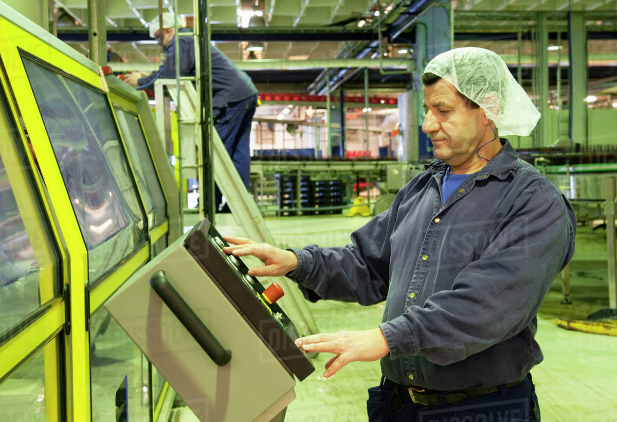 Two workers checking machine - Royalty-free Stock Photo | Dissolve