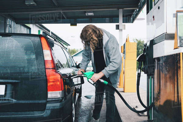 Full length of man refueling car at gas station - Royalty-free Stock ...