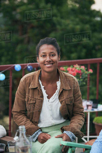 Portrait of smiling confident woman partying on terrace - Royalty-free ...