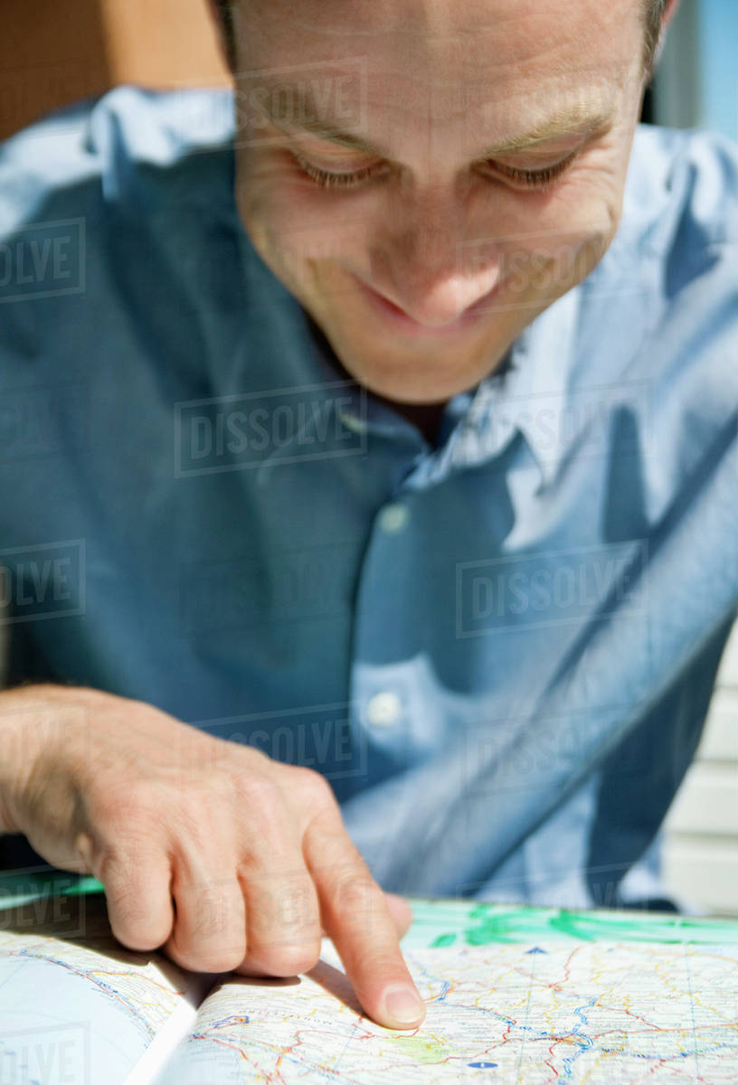 Man pointing at map - Royalty-free Stock Photo | Dissolve