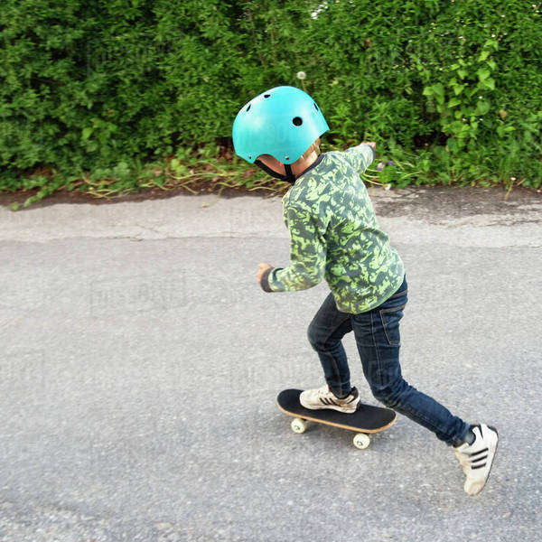 Boy riding skateboard - Stock Photo - Dissolve
