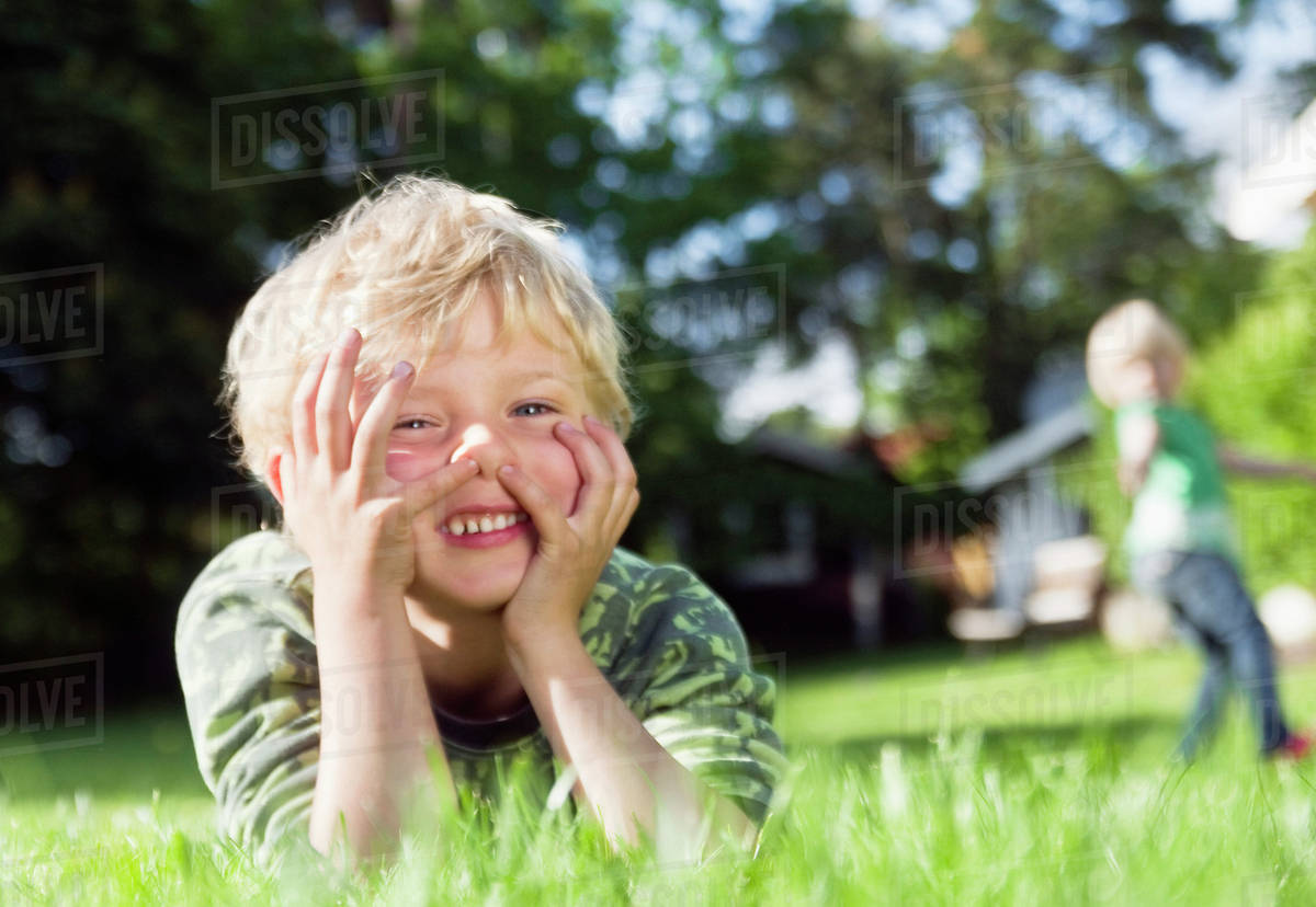 Children playing on grass - Royalty-free Stock Photo | Dissolve