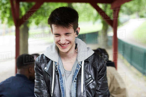 Smiling teenage boy with eyes closed - Stock Photo - Dissolve