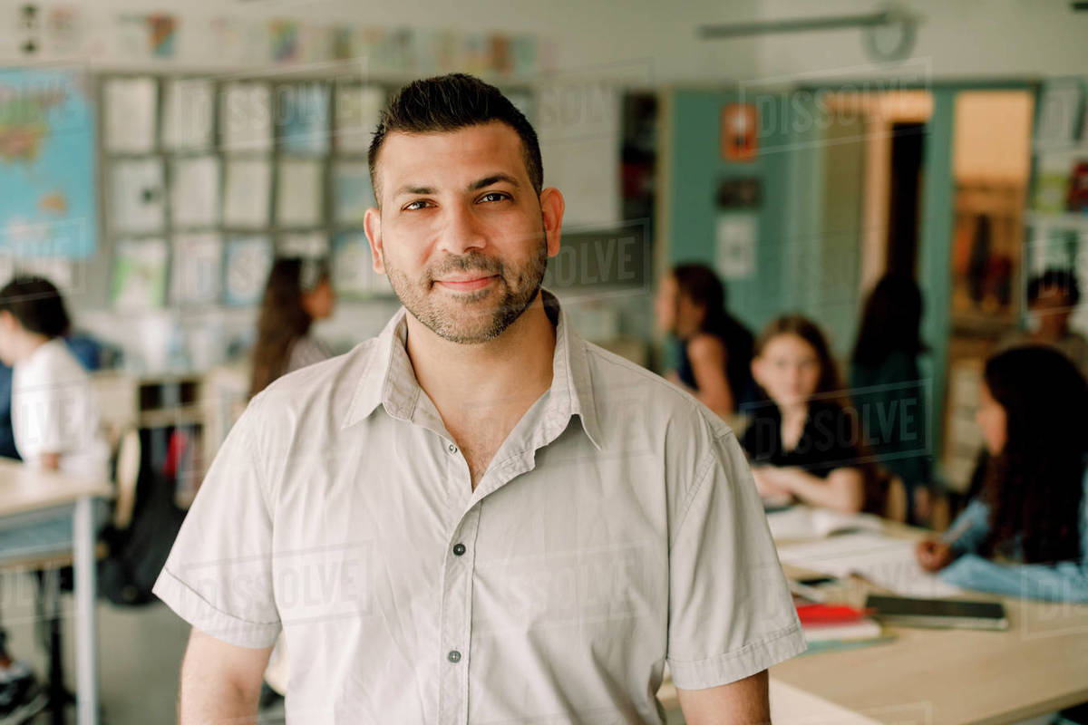 Portrait of smiling male tutor standing in classroom - Stock Photo ...