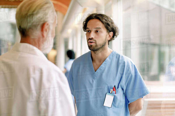 Contemplating nurse talking to senior expert in hospital - Stock Photo ...