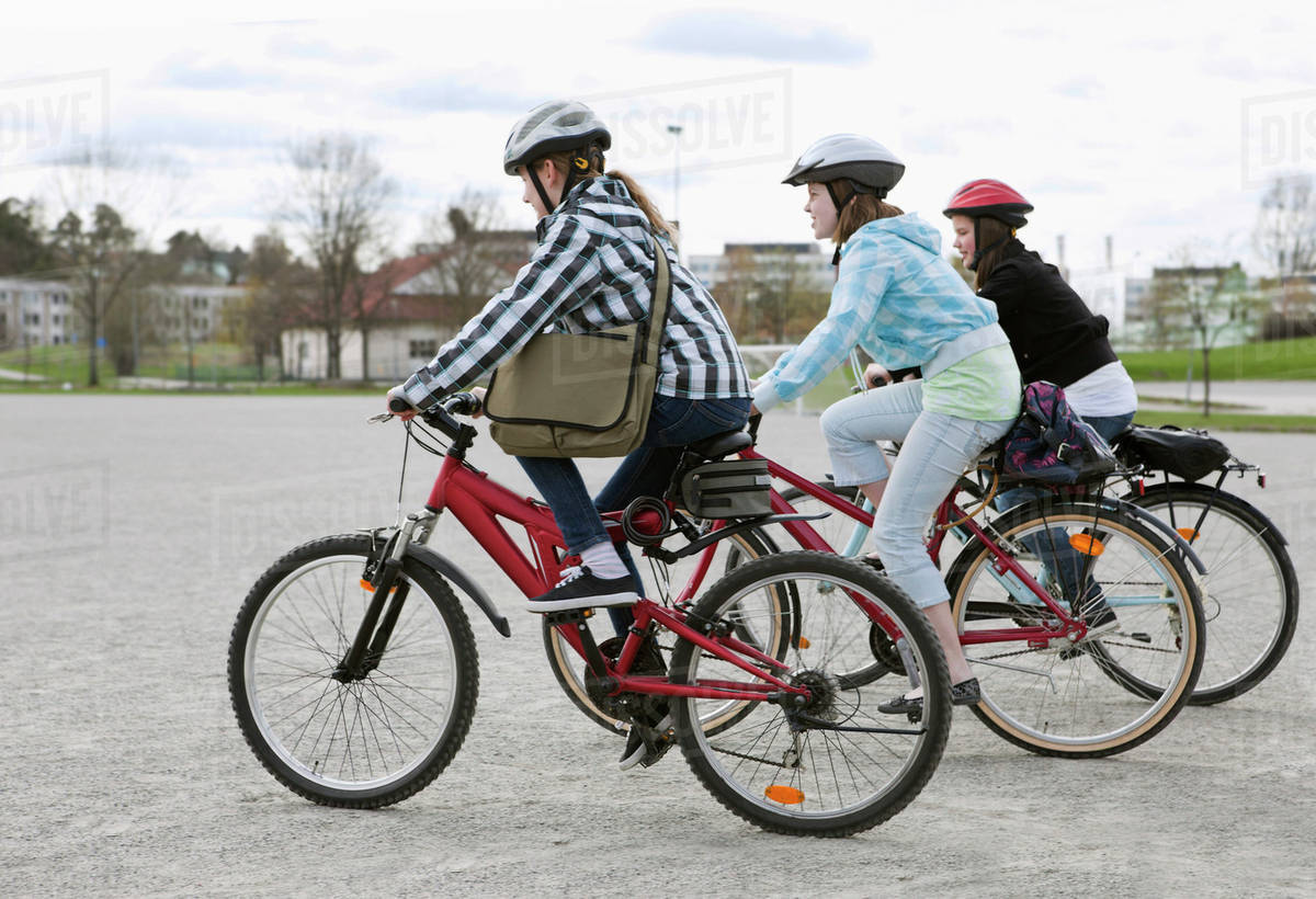 Three friends biking - Royalty-free Stock Photo | Dissolve