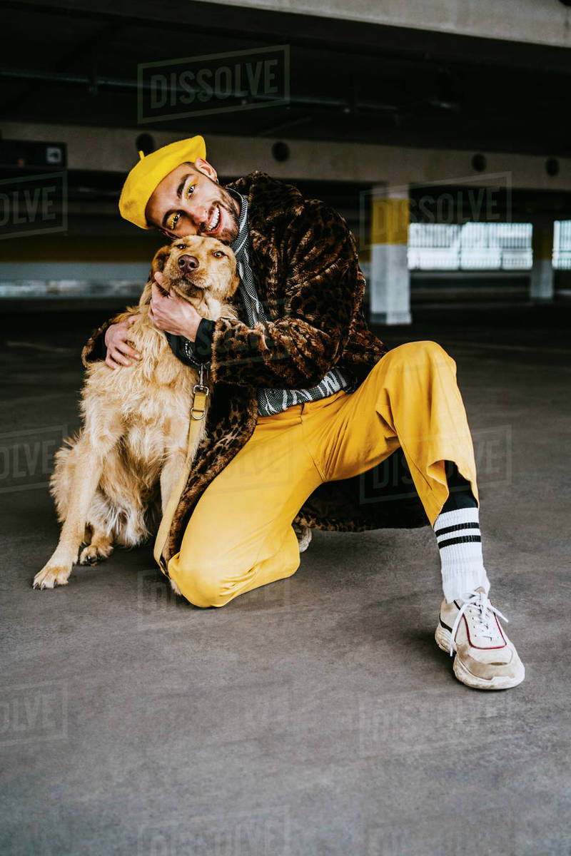 Full length of young man hugging dog in parking garage - Stock Photo ...