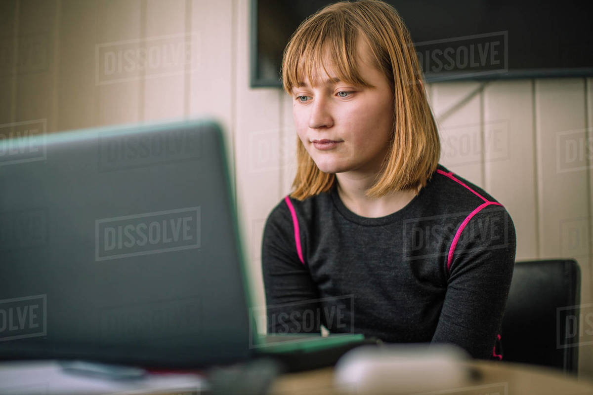Girl E-learning through laptop in living room at home - Royalty-free ...