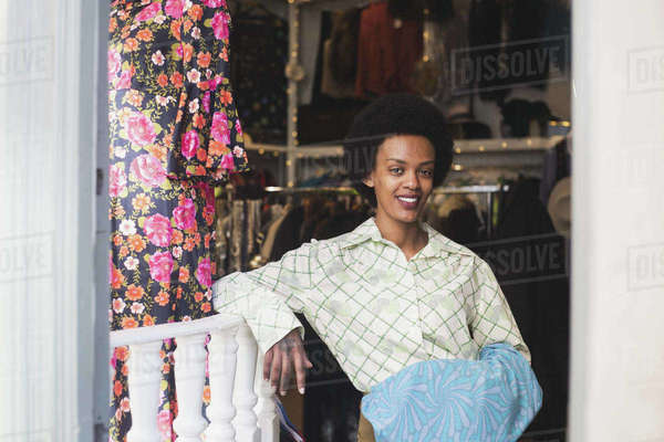 Portrait of smiling female employee standing in store - Royalty-free ...