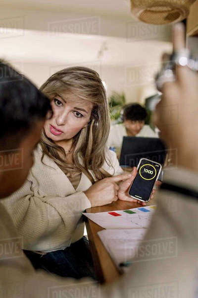 Mother showing smart phone to son at home - Royalty-free Stock Photo ...