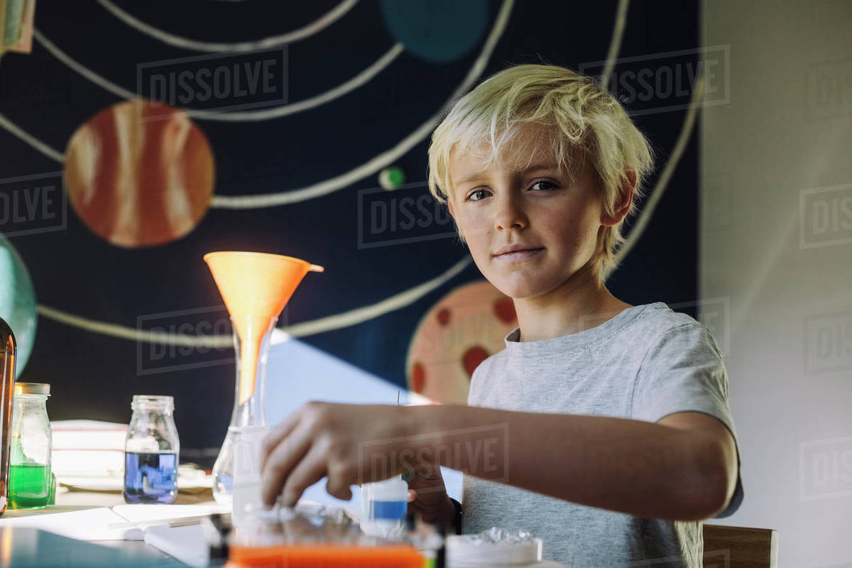 Portrait of boy doing scientific experiment at home - Royalty-free ...