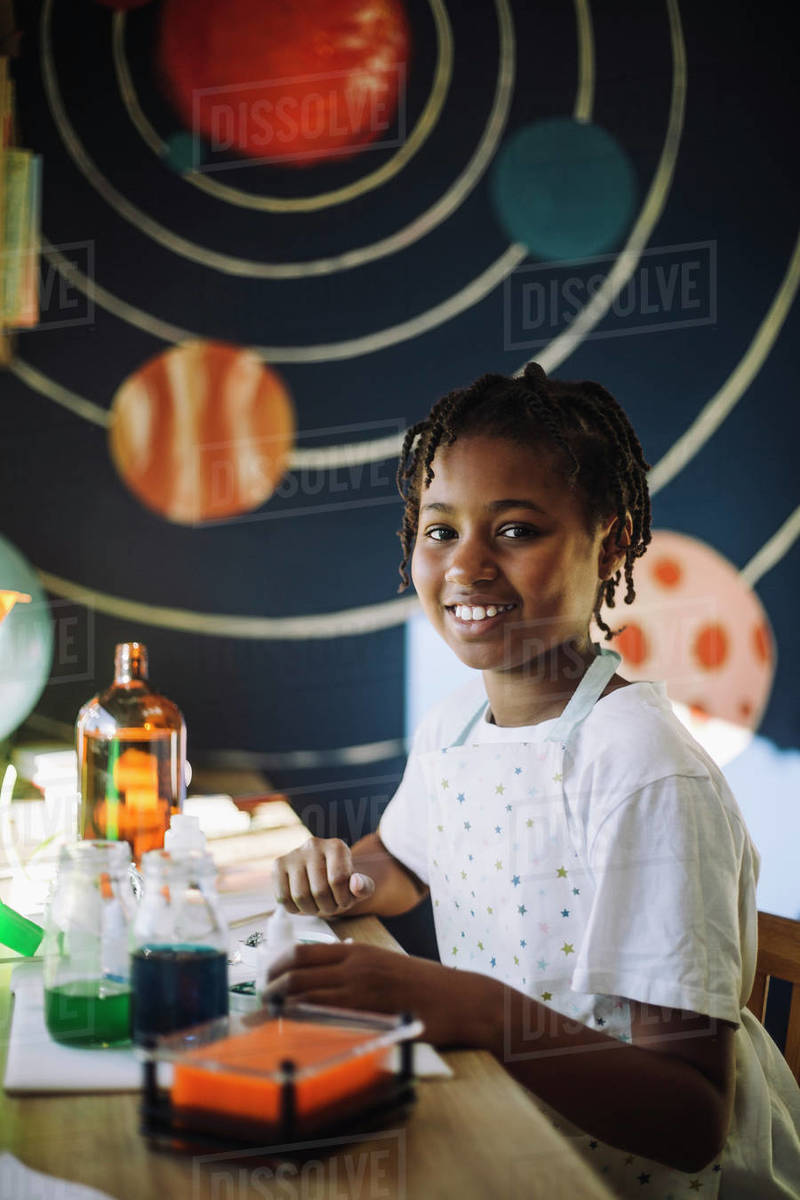 Portrait of smiling girl doing scientific experiment at home - Stock ...