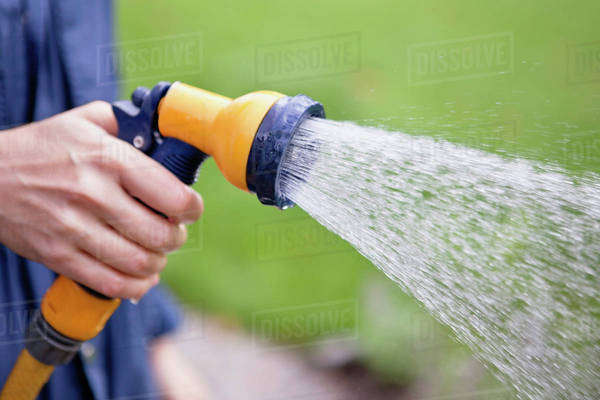 Waterhose spraying water - Royalty-free Stock Photo | Dissolve