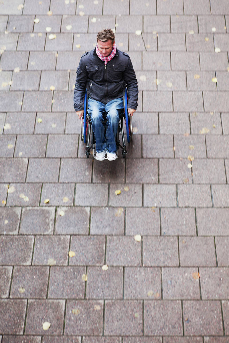 Man travelling in wheelchair - Royalty-free Stock Photo | Dissolve
