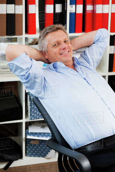 Happy man at work taking a break - Royalty-free Stock Photo | Dissolve