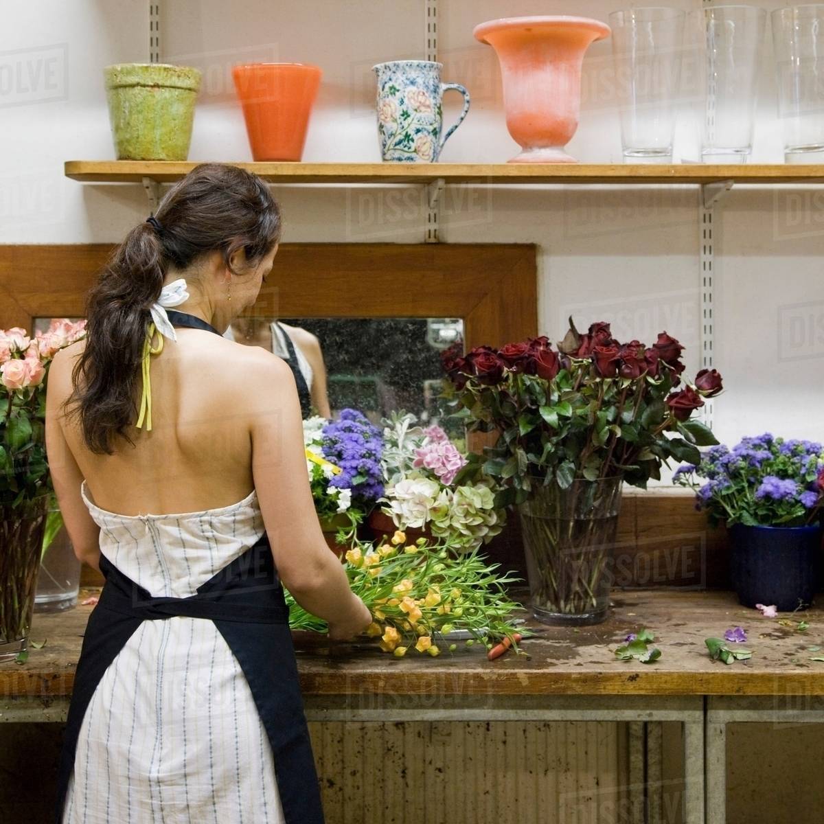 Female clerk in a flower shop - Royalty-free Stock Photo | Dissolve