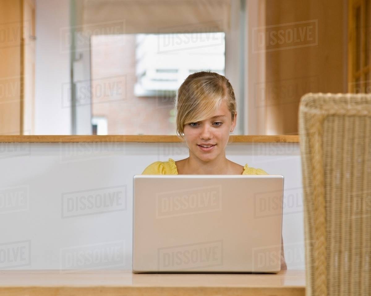Young girl working on a laptop computer - Royalty-free Stock Photo ...