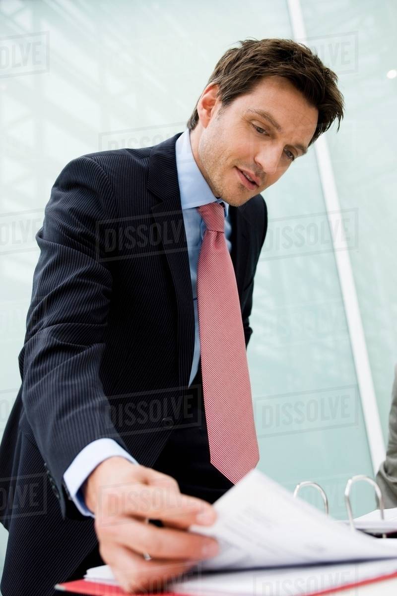 Man studying papers - Royalty-free Stock Photo | Dissolve