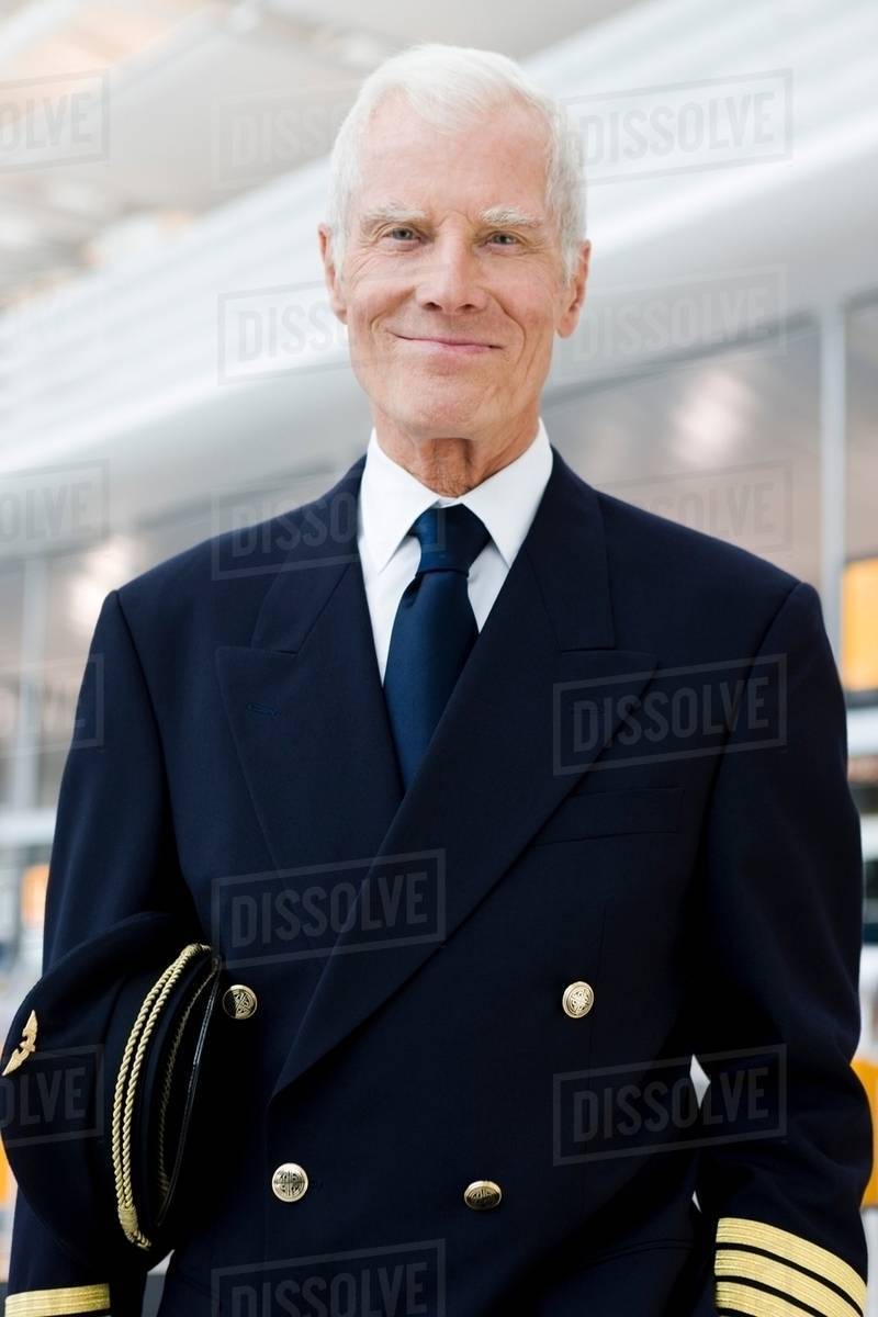 Flight captain smiling at viewer - Stock Photo - Dissolve