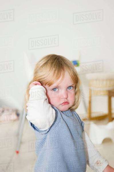 A little girl looking grumpy - Royalty-free Stock Photo | Dissolve