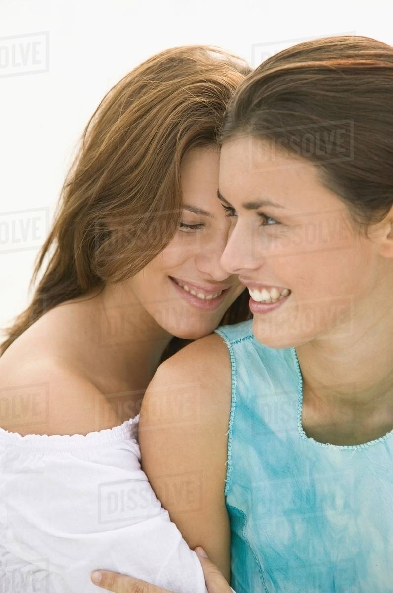 Smiling friends embracing - Royalty-free Stock Photo | Dissolve