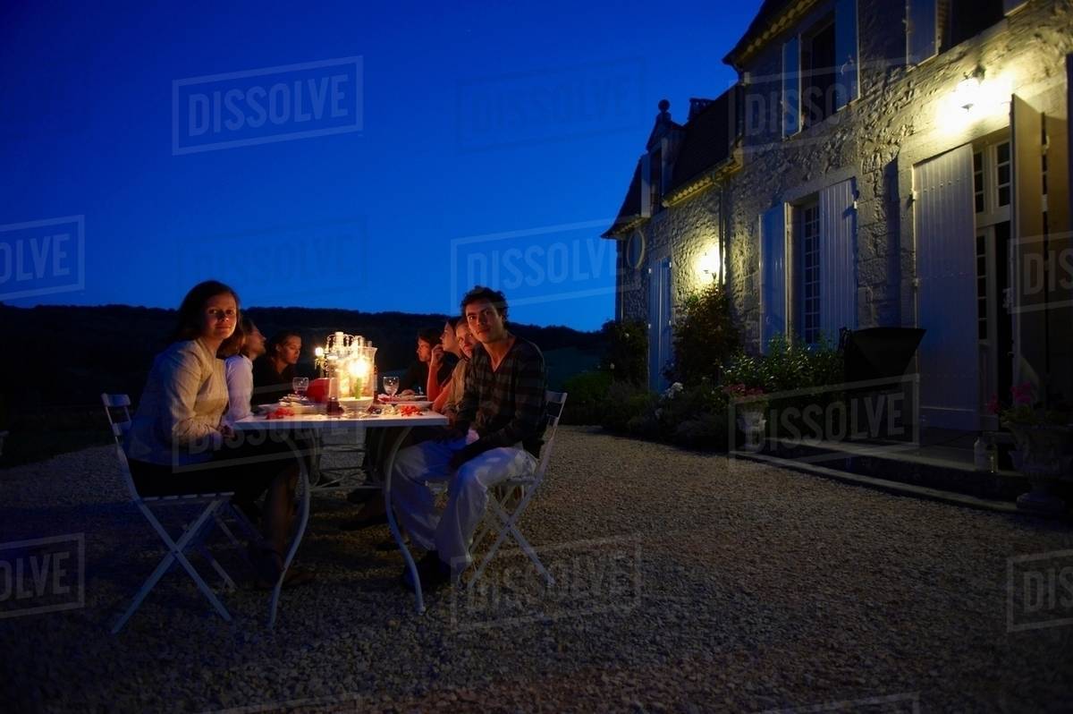 Friends having dinner outside - Royalty-free Stock Photo | Dissolve