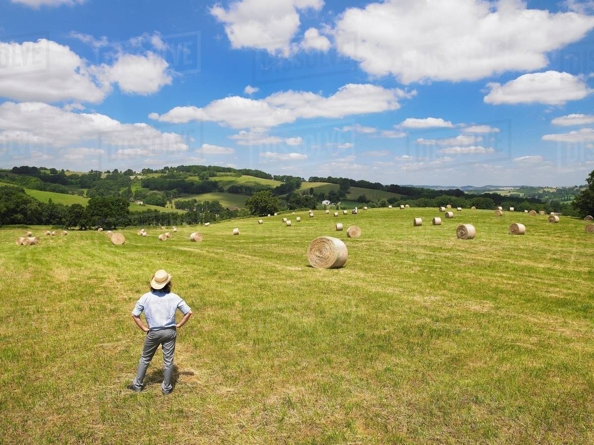 Man standing in field - Royalty-free Stock Photo | Dissolve