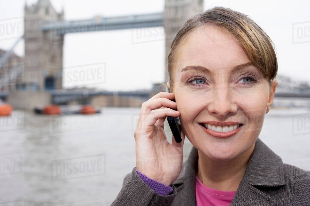 Business woman using mobile outside - Stock Photo - Dissolve
