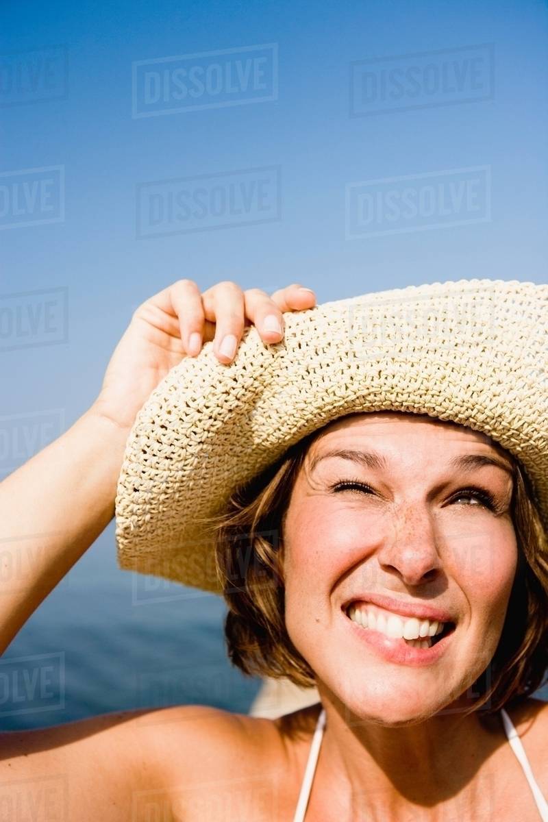 Woman with hat smiling - Royalty-free Stock Photo | Dissolve