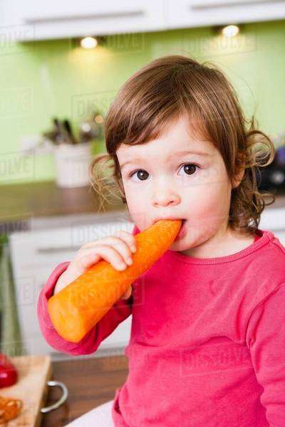 Child eating carrot - Royalty-free Stock Photo | Dissolve