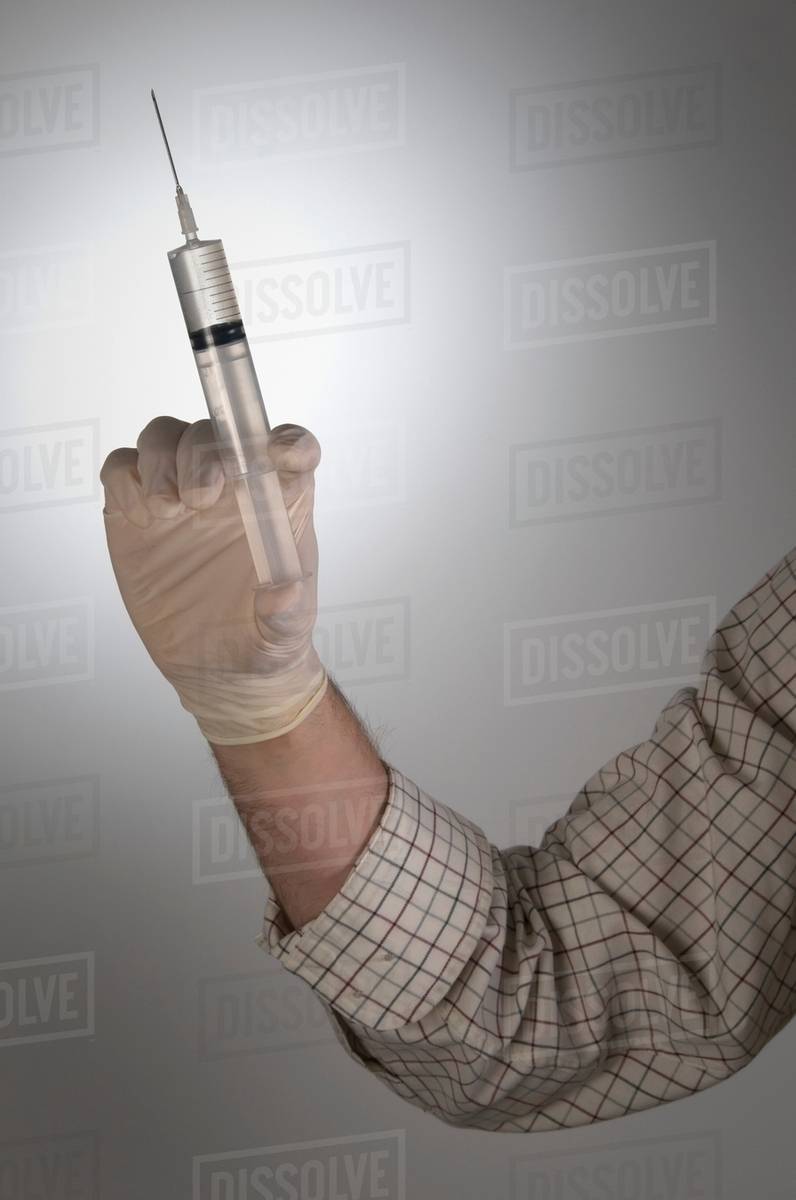 Male holding syringe - Royalty-free Stock Photo | Dissolve