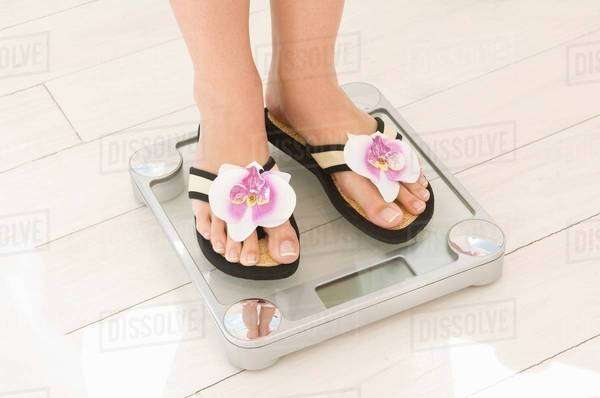 Feet on scales - Royalty-free Stock Photo | Dissolve