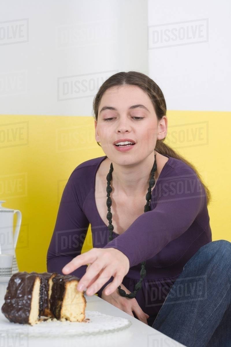 Young woman with cake - Stock Photo - Dissolve