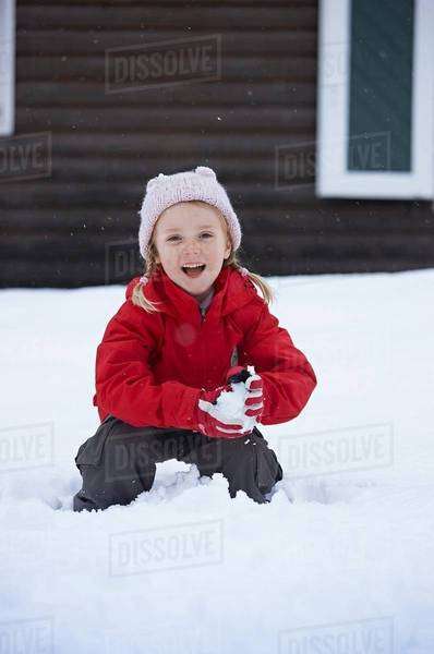 Little girl playing in snow - Royalty-free Stock Photo | Dissolve