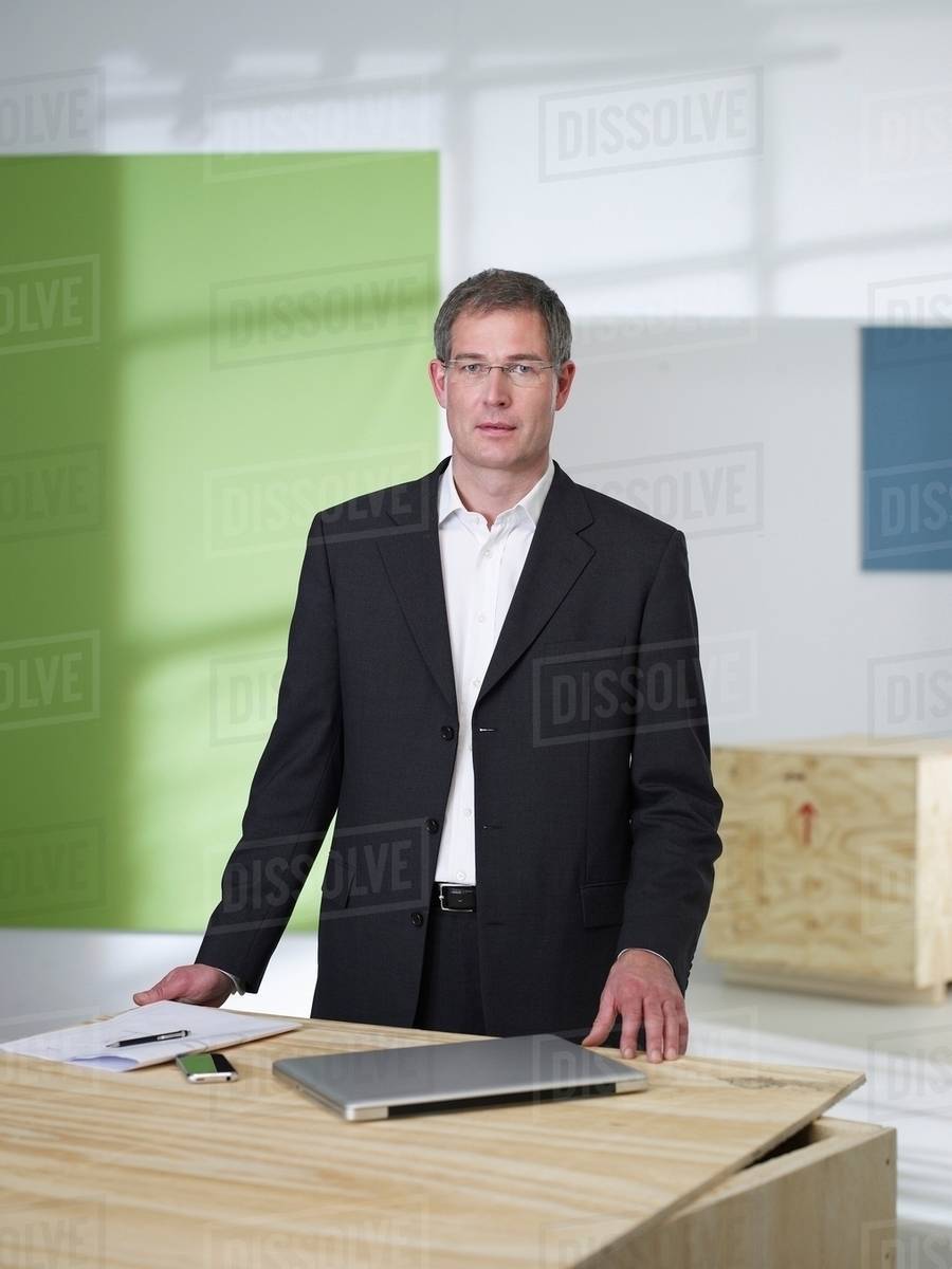 Manager standing in loft office - Royalty-free Stock Photo | Dissolve