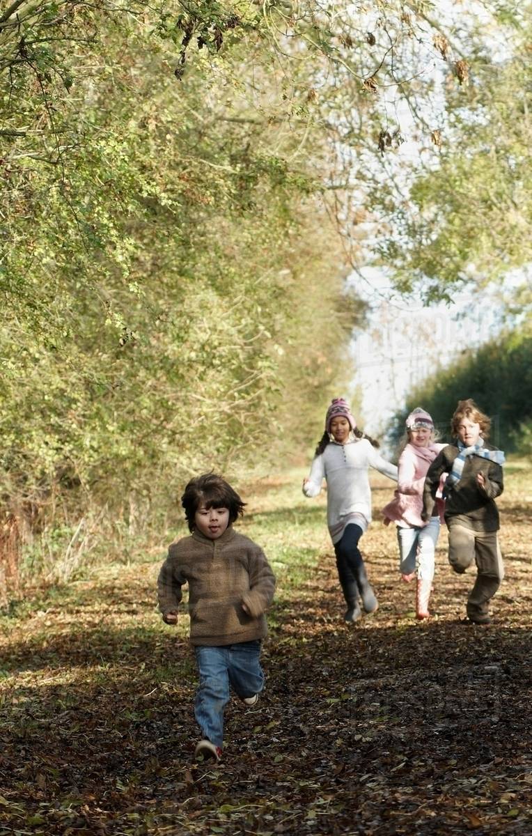 Children running down country lane - Royalty-free Stock Photo | Dissolve