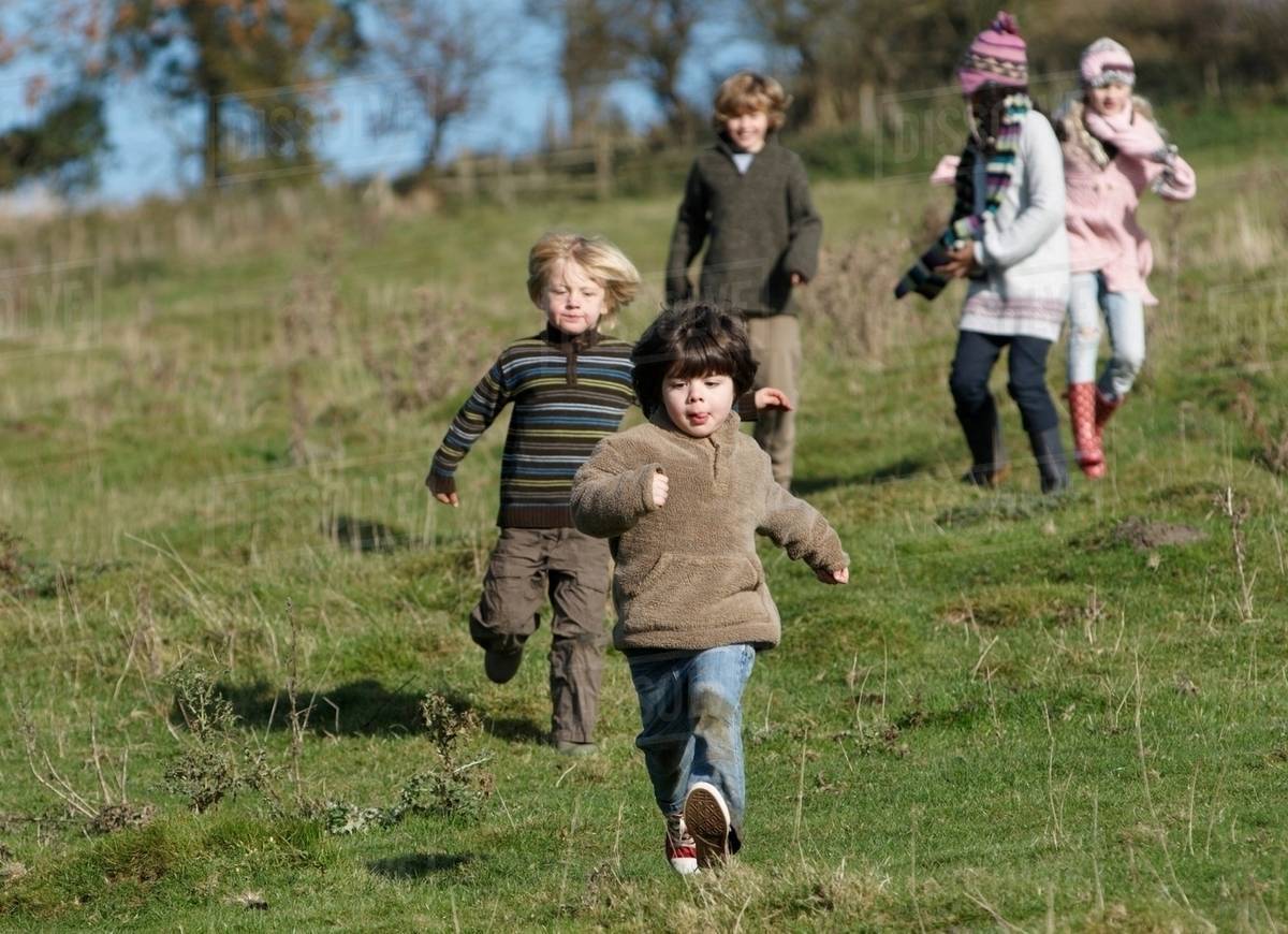 Children running in countryside - Royalty-free Stock Photo | Dissolve
